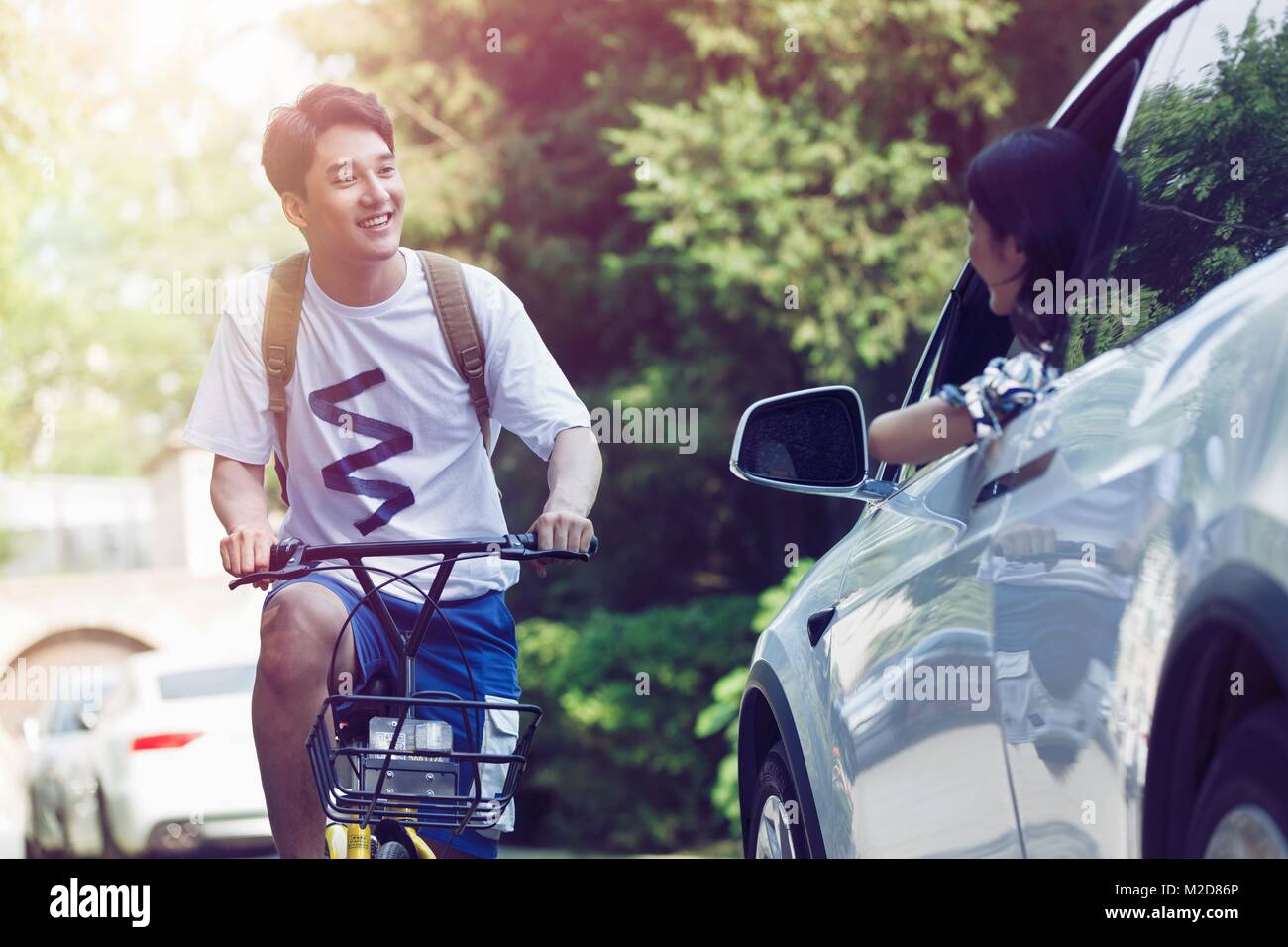 Young men ride bicycles hi-res stock photography and images - Alamy