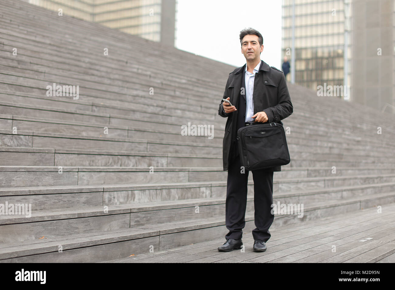 European businessman walking and speaking by telephone Stock Photo - Alamy