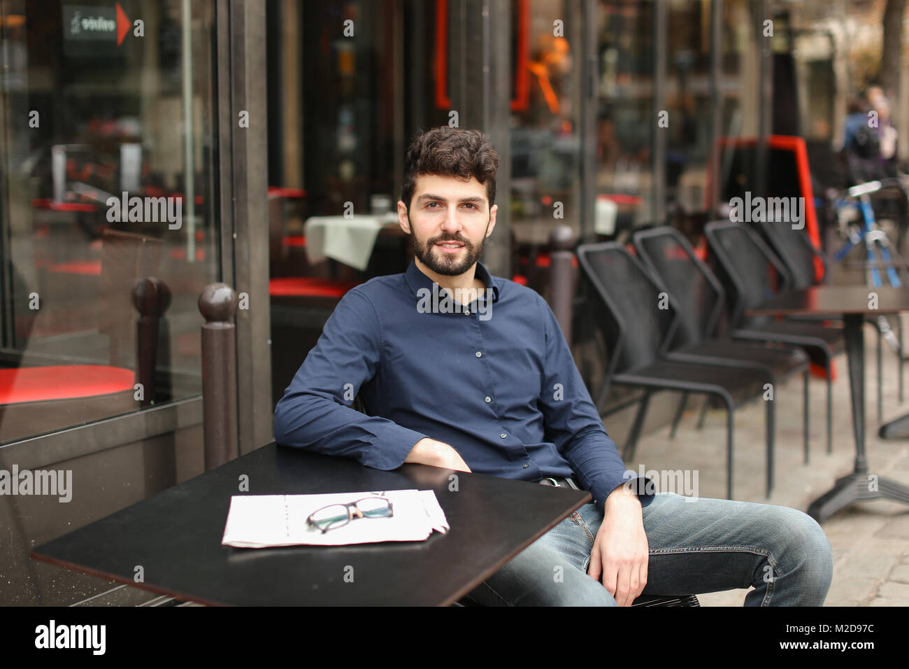 Journalist with close up face reading newspaper article at cafe Stock ...
