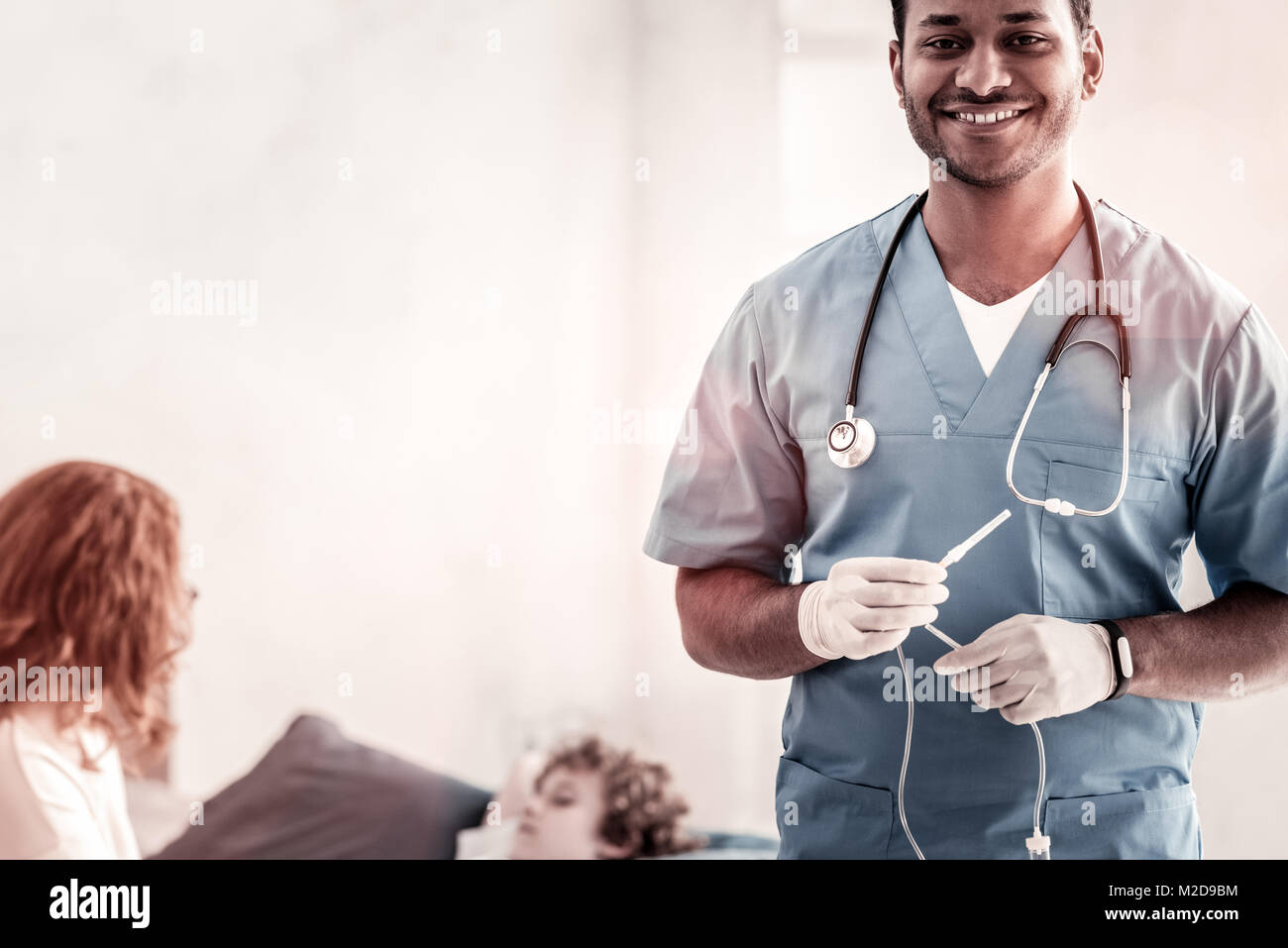 Cheerful doctor preparing drip for insertion Stock Photo - Alamy