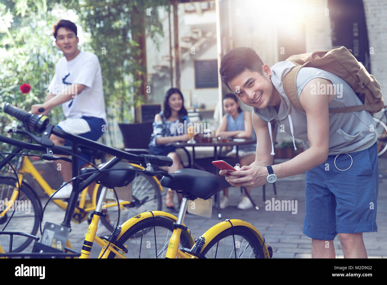Young people ride bicycles Stock Photo - Alamy