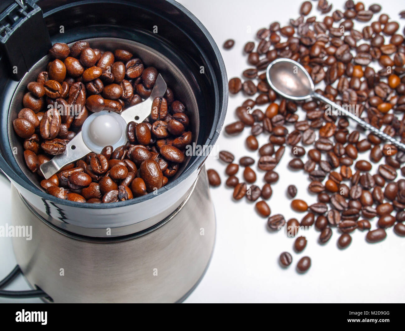 Electric coffee grinder with roasted coffee beans inside and coffee ...