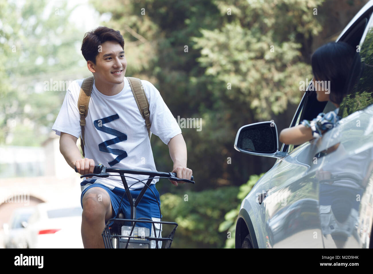 Young men ride bicycles Stock Photo - Alamy