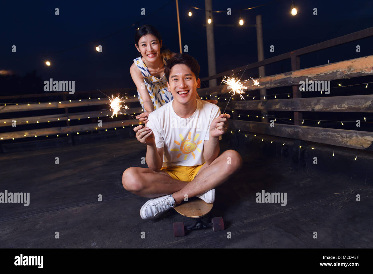 Two people sit on roof hi-res stock photography and images - Alamy