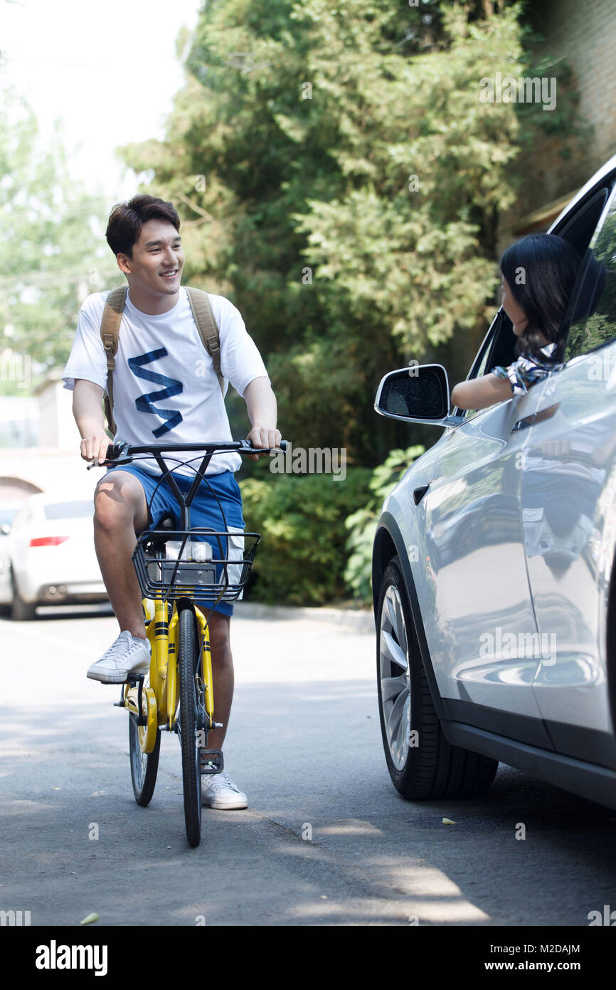 Young men ride bicycles Stock Photo - Alamy