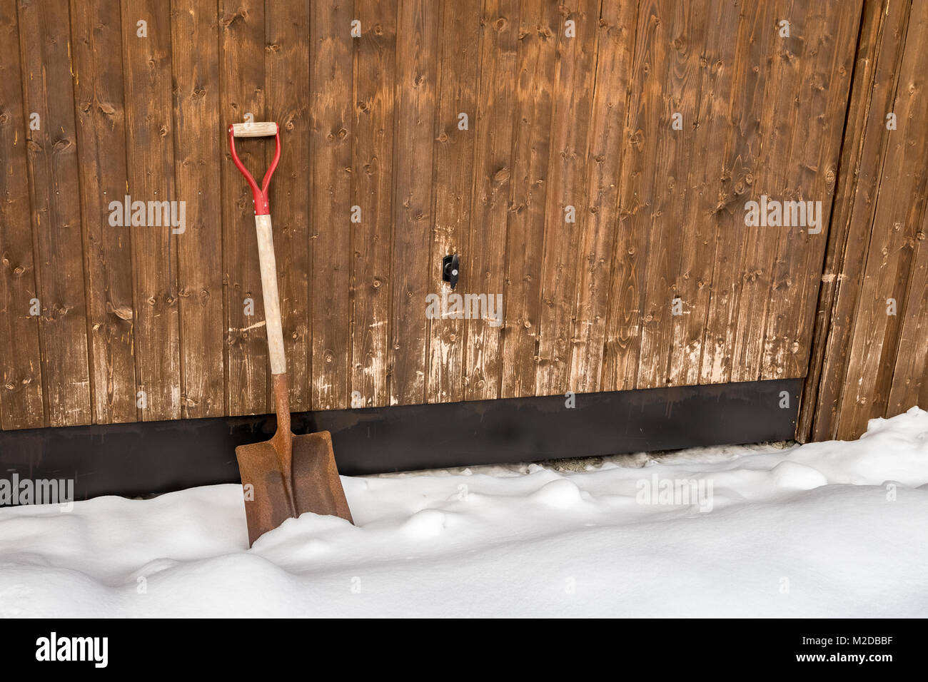 Old rusted shovel in the snow outside a garage door Stock Photo - Alamy