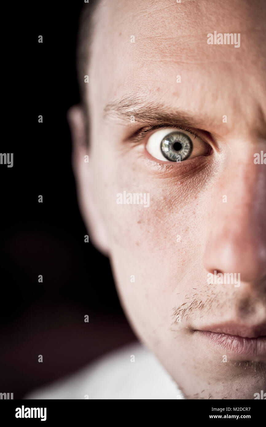portrait of a young man with eyes wide open Stock Photo - Alamy