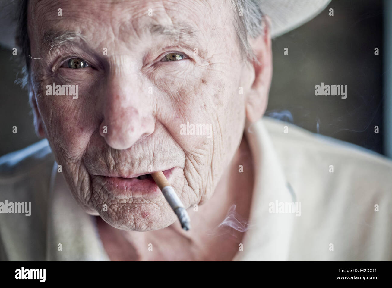 a old man smoking Stock Photo - Alamy