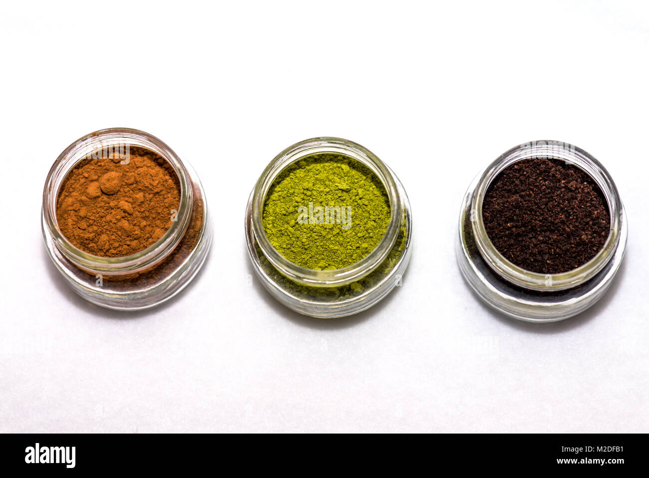 Ground cocoa, coffee and matcha in glass jars, natural antioxidants ...