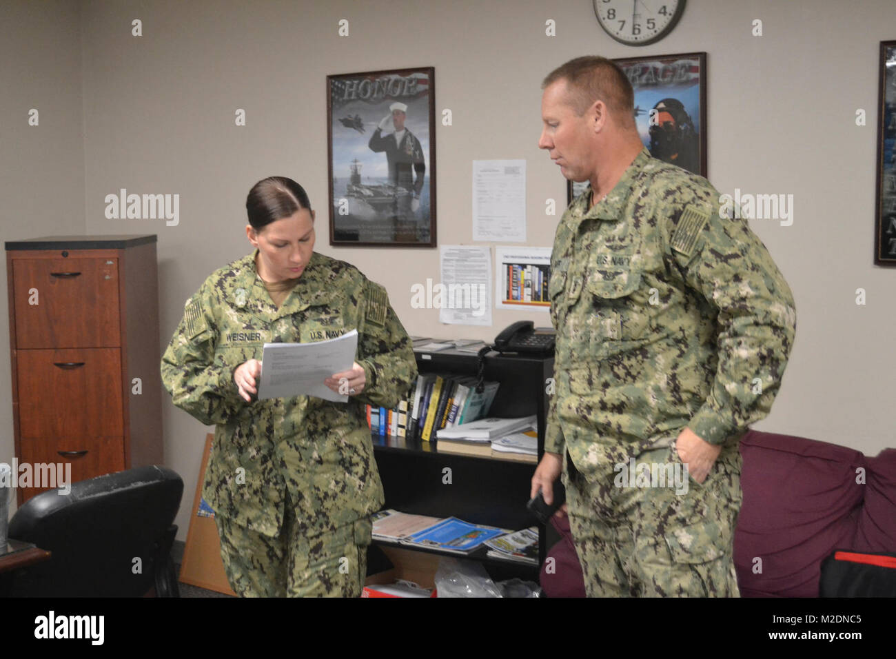 Danielle Weisner helps Chief Warrant Officer Chad Ruff with paperwork ...