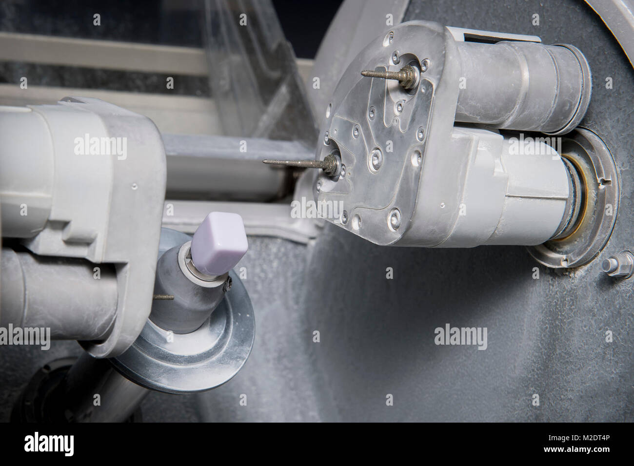 A ceramic core sits inside computer aided manufacturing machine used by ...