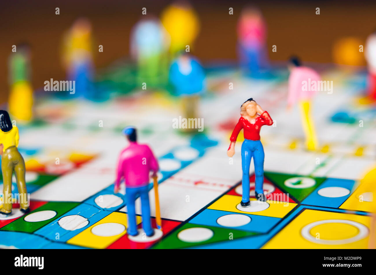Retro ludo board with miniature human figures from China in studio ...