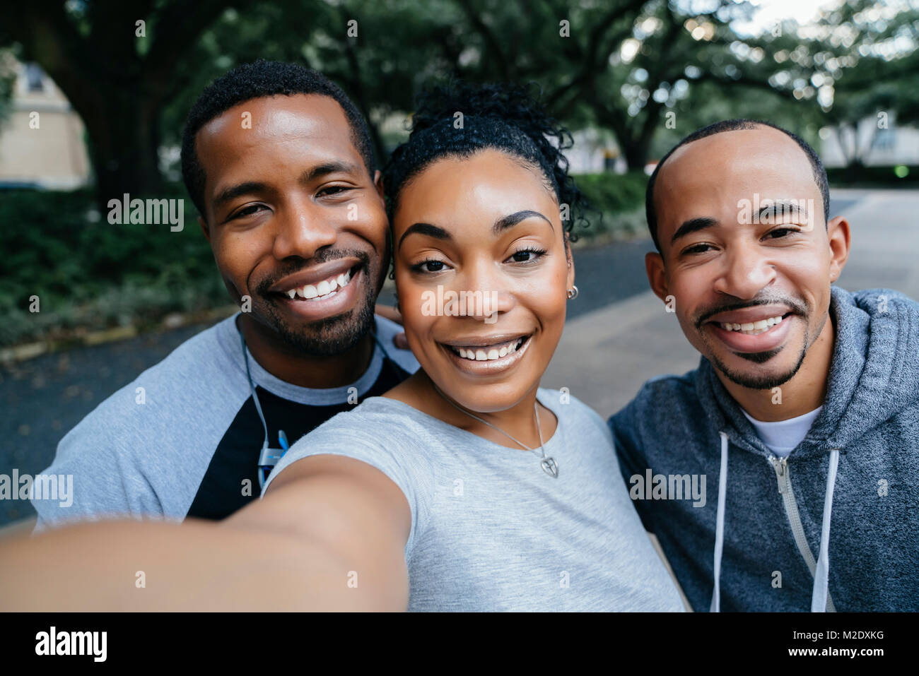 Smiling Black friends posing for cell phone selfie Stock Photo - Alamy