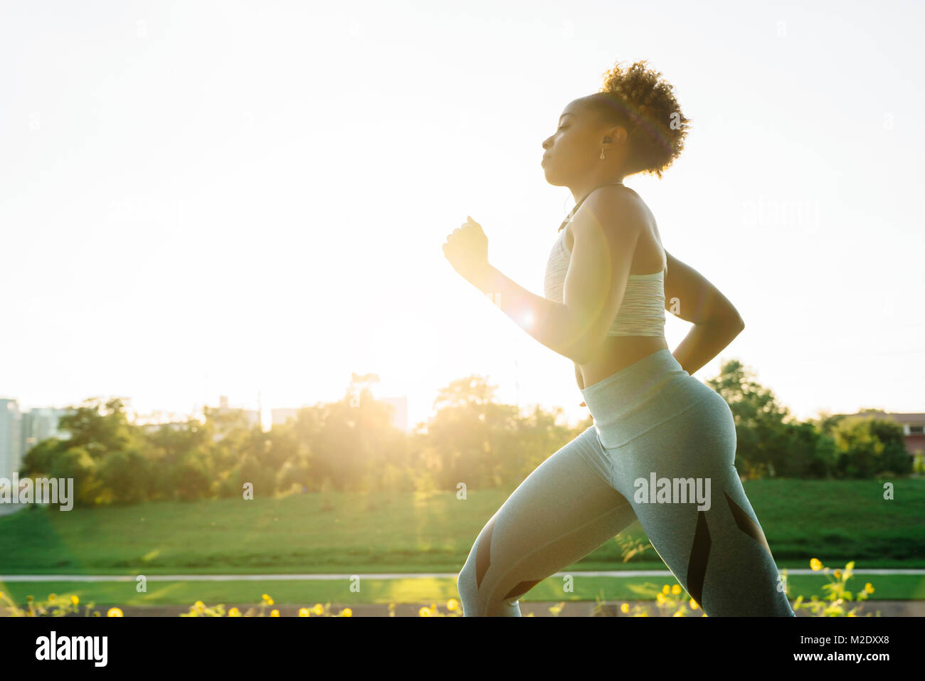 Mixed Race woman running in park Stock Photo - Alamy