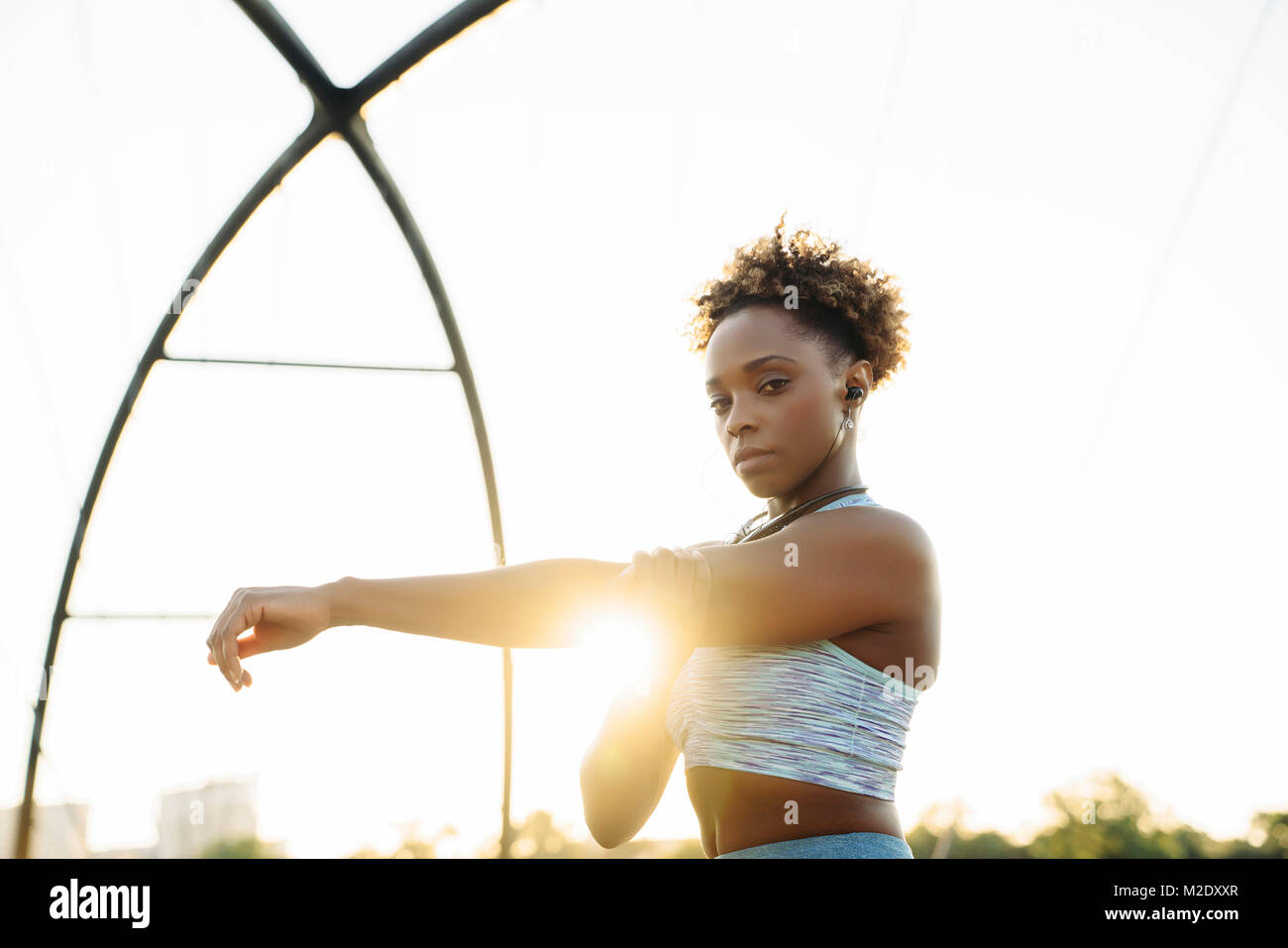Portrait of mixed race woman stretching arms Stock Photo - Alamy