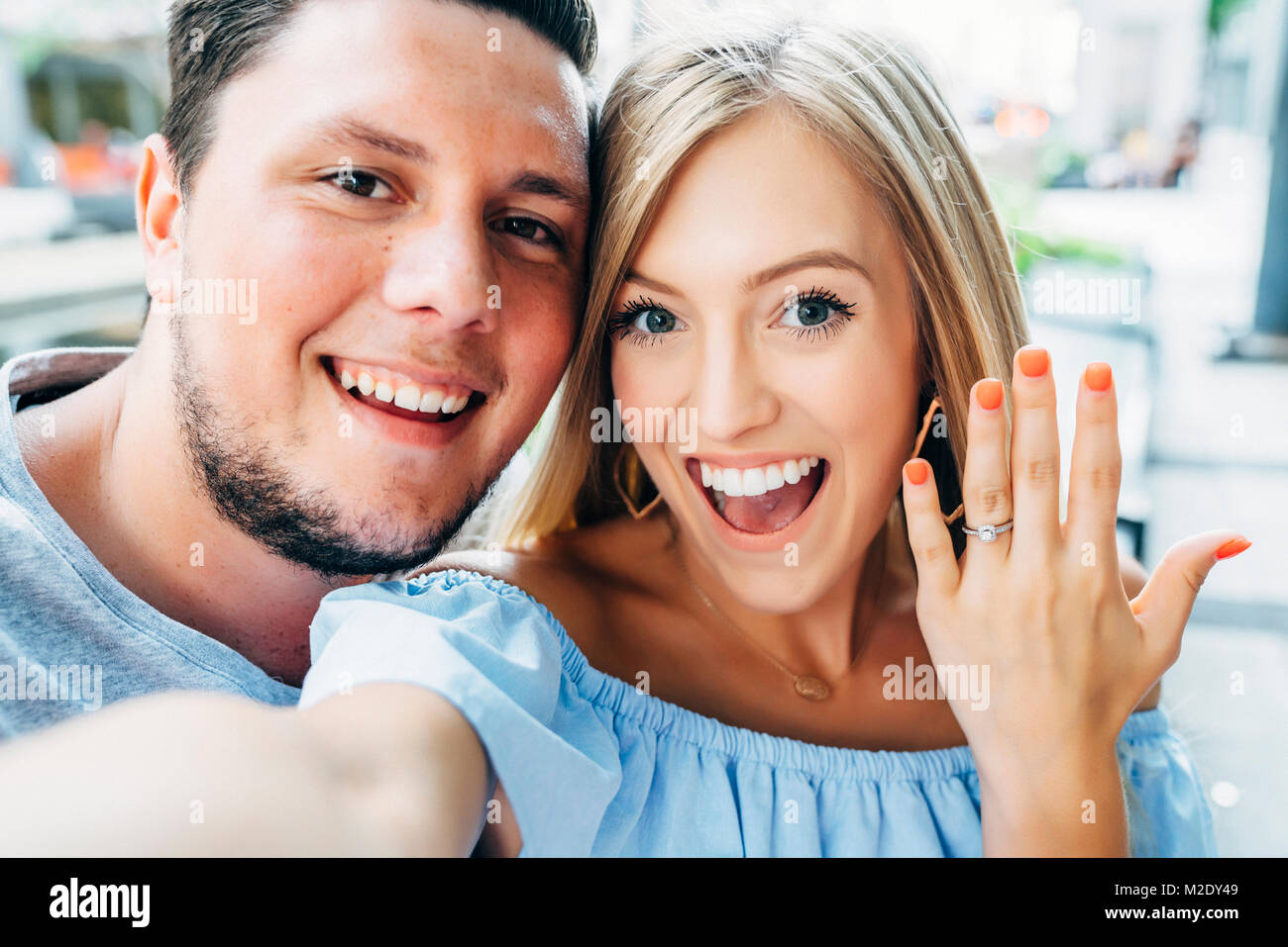 Smiling Caucasian couple posing for selfie with engagement ring Stock ...
