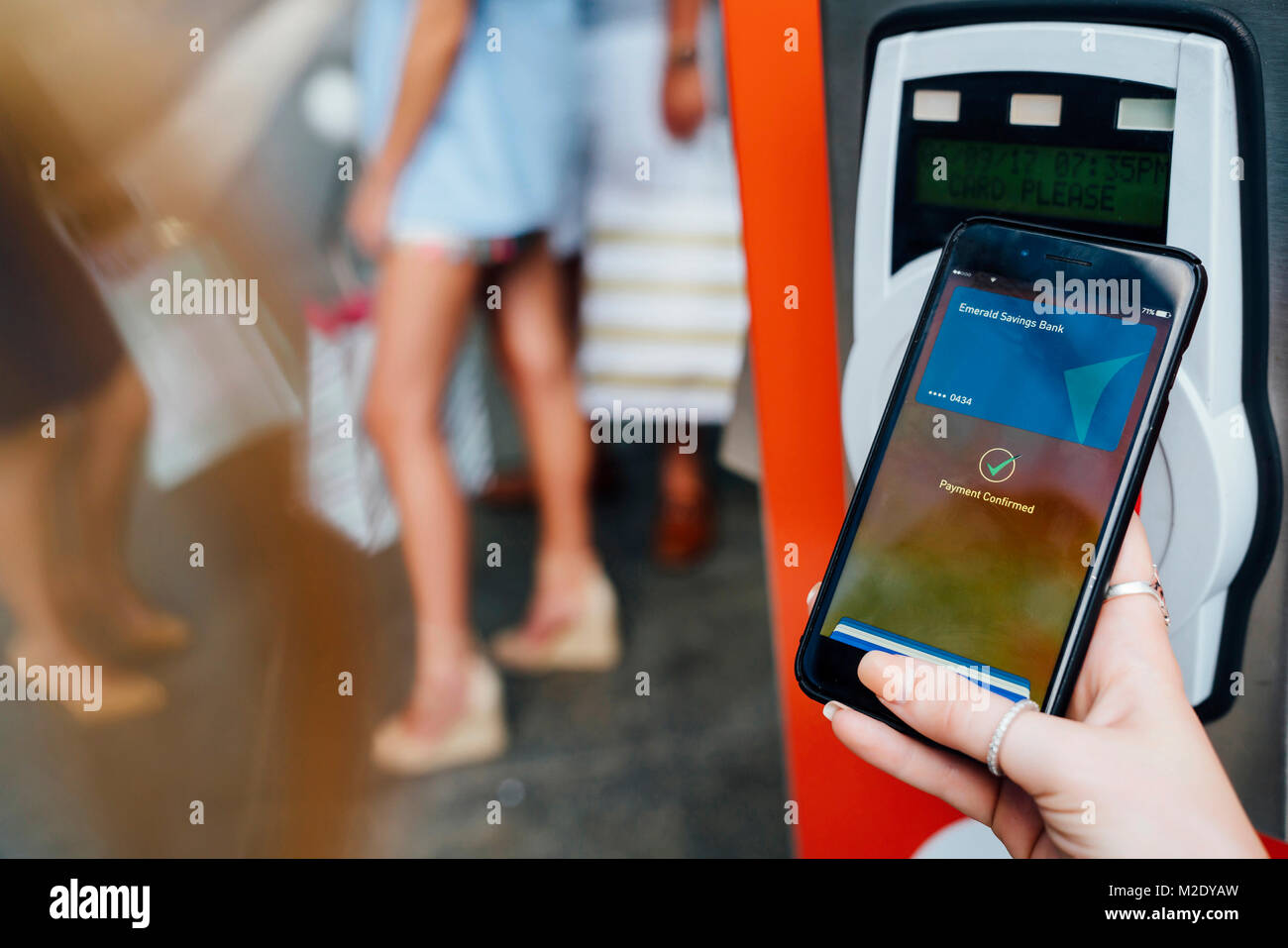 Hand of woman paying at kiosk using cell phone Stock Photo - Alamy