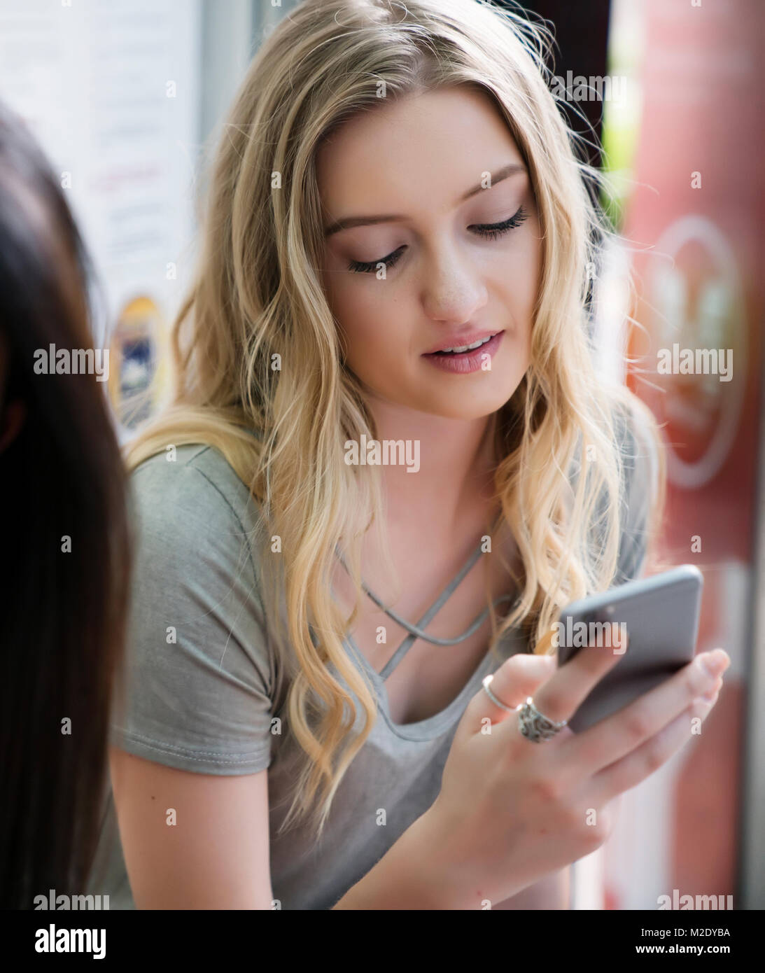 Curious Caucasian woman texting on cell phone Stock Photo - Alamy