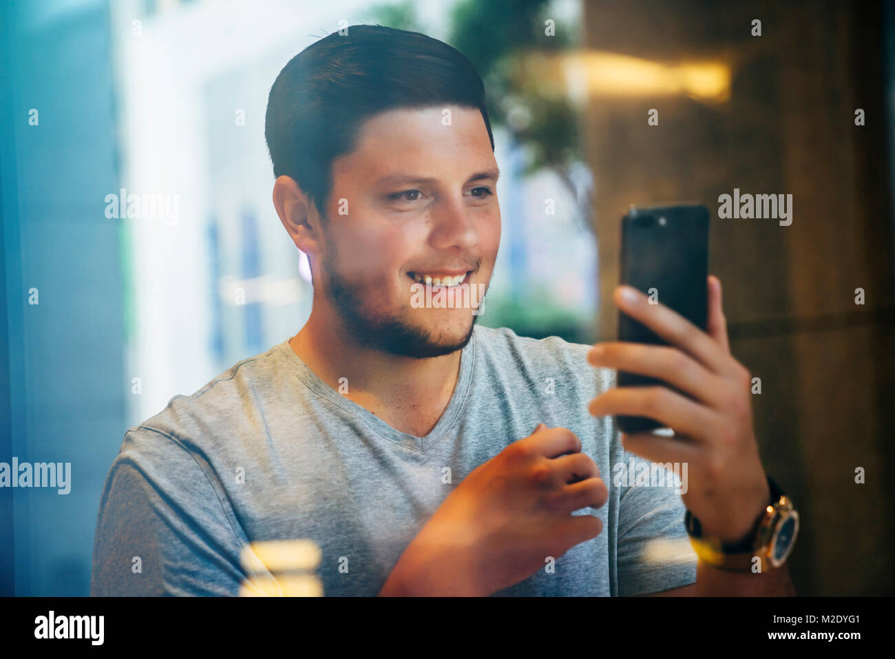 Smiling Caucasian man posing for cell phone selfie Stock Photo - Alamy