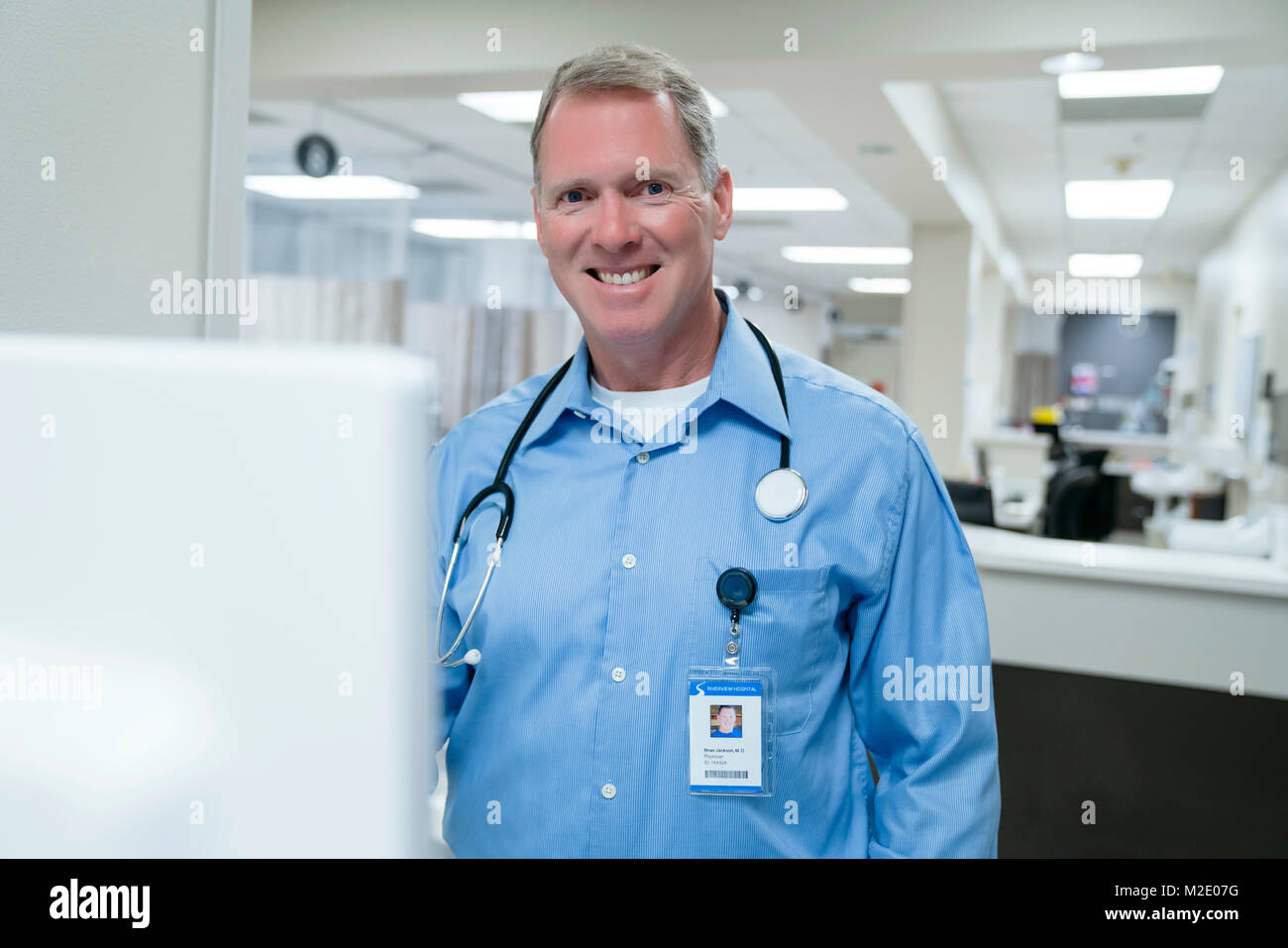 Portrait of smiling doctor using computer in hospital Stock Photo - Alamy