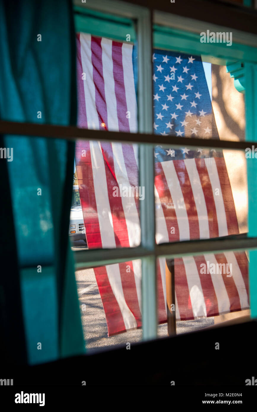 American flag hanging outside window Stock Photo - Alamy