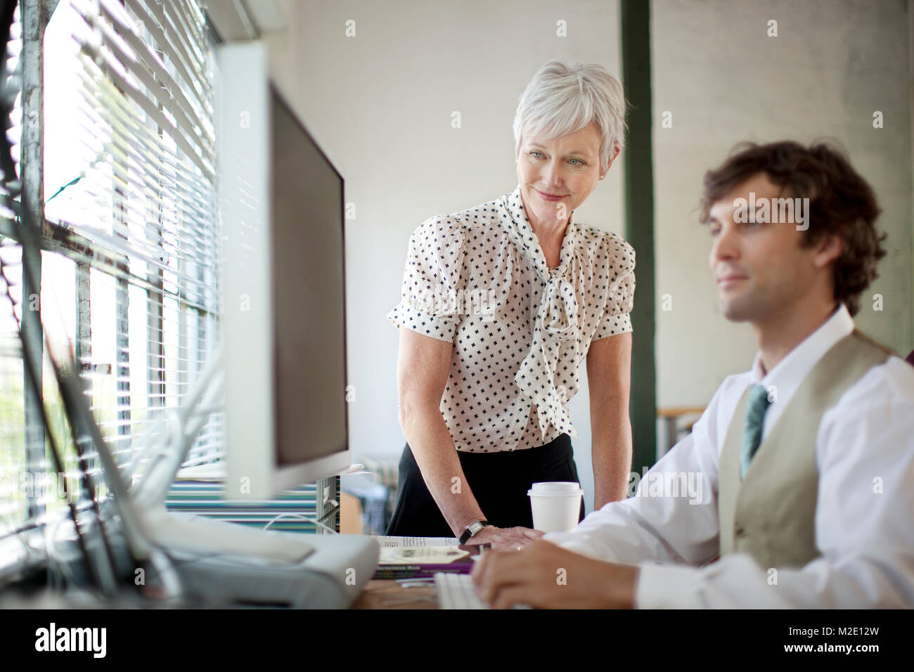 Business people using computer in office Stock Photo - Alamy