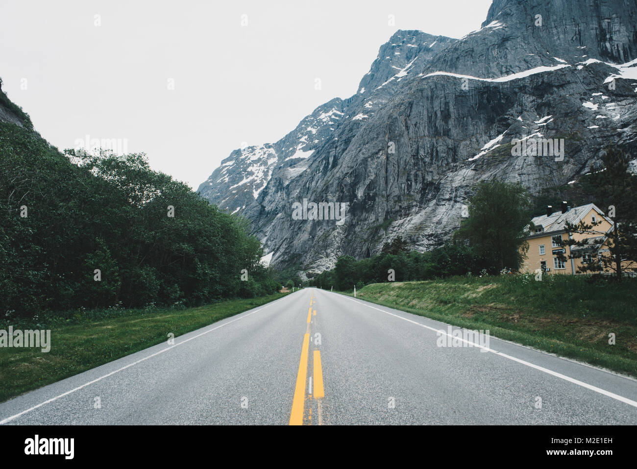 House near empty road in mountain landscape Stock Photo - Alamy