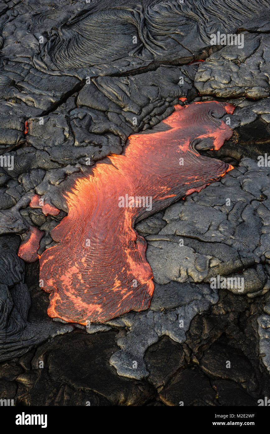 Molten lava glowing near dried lava Stock Photo - Alamy