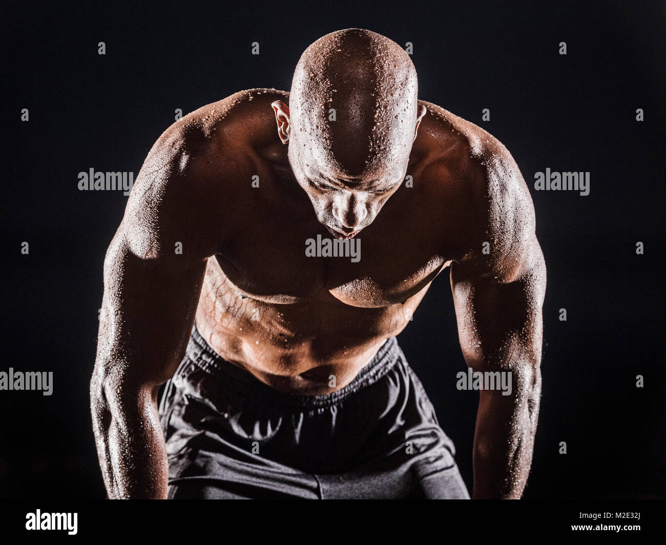 Sweating Black man bending and resting Stock Photo - Alamy