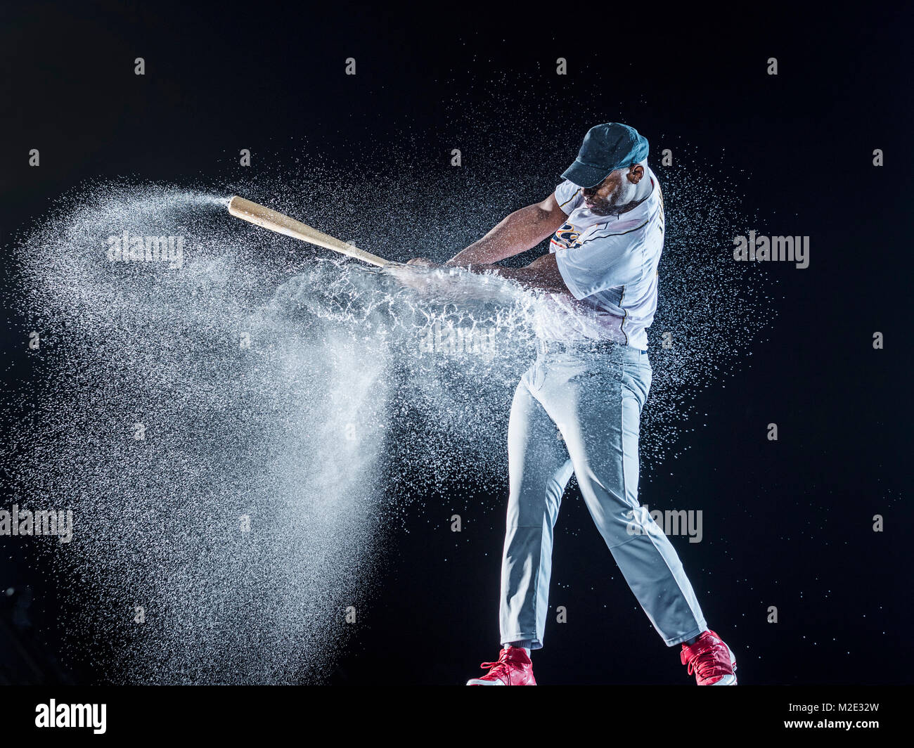 Water splashing on Black baseball player swinging bat Stock Photo - Alamy