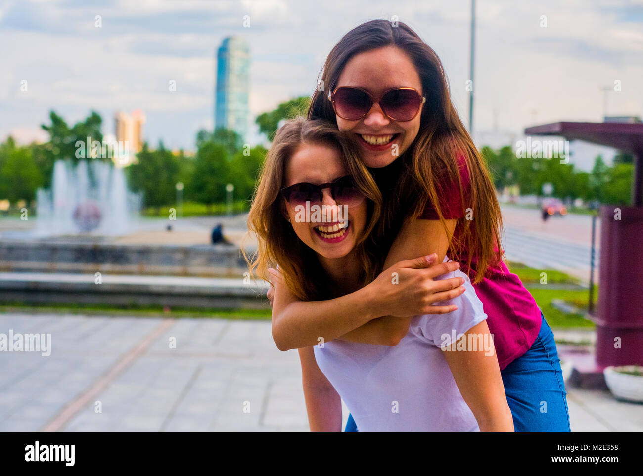 Portrait of smiling women hugging Stock Photo - Alamy