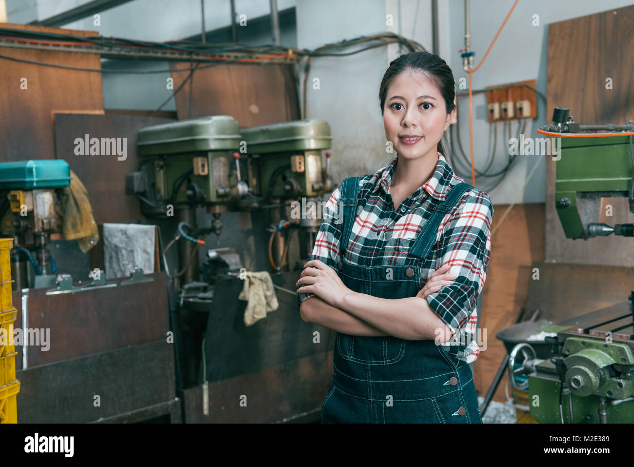 confident happy lathe factory woman employee hands crossed put on chest ...