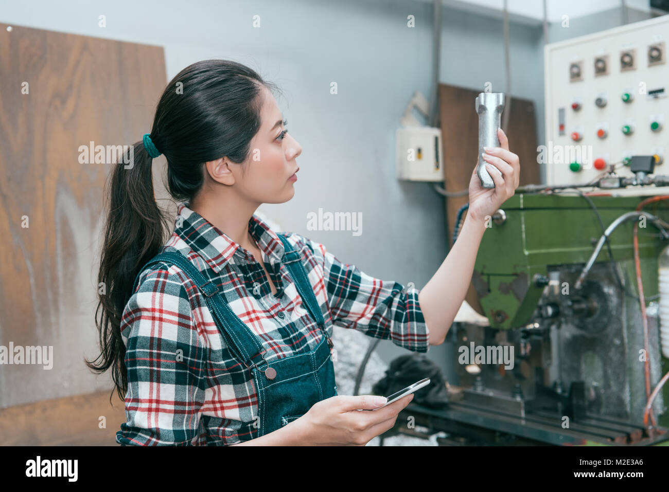pretty elegant milling machine company female worker working with ...