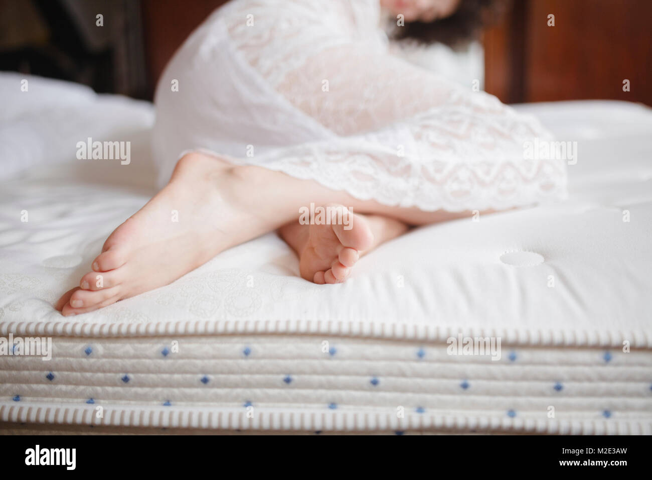Woman laying on bed feet hi-res stock photography and images - Alamy