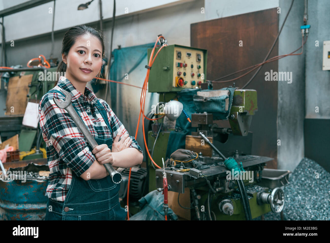 confident professional lathe factory worker woman standing in milling ...