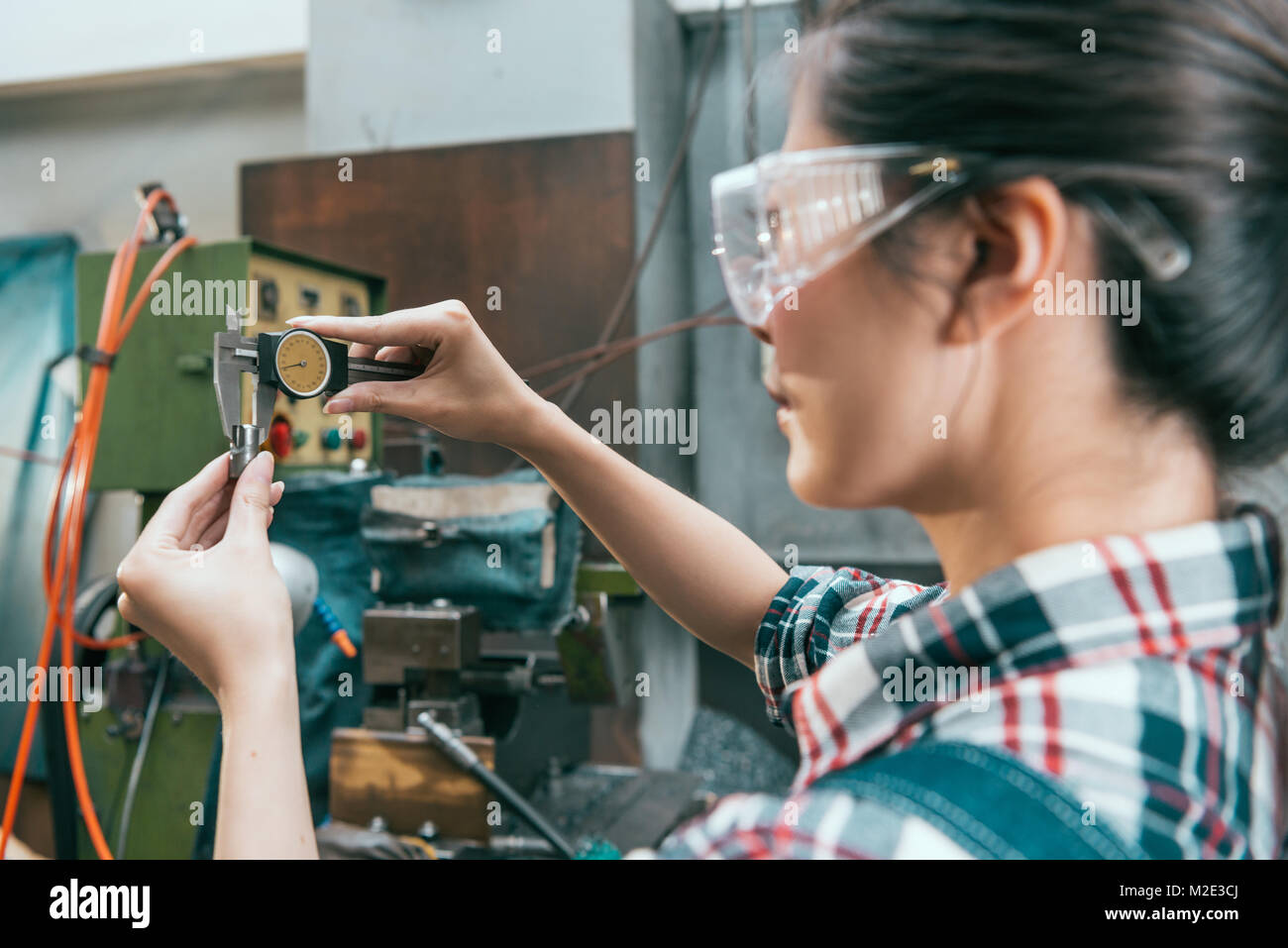 selective focus photo of milling machine factory female manager using ...