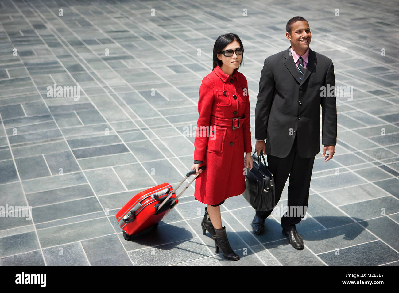 Business people with briefcase and rolling suitcase Stock Photo - Alamy