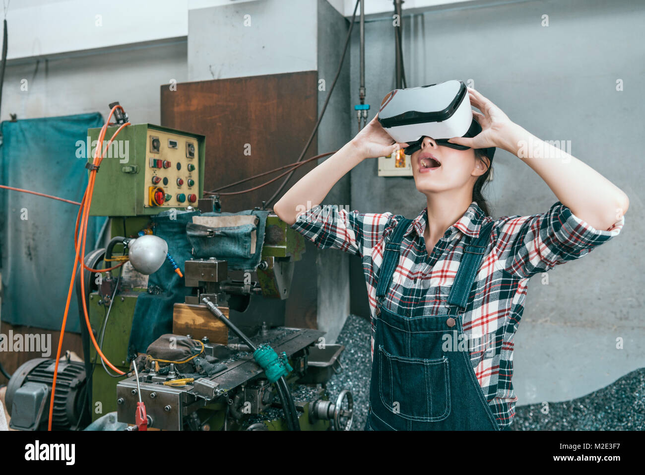 cheerful pretty milling machine company factory female worker using ...