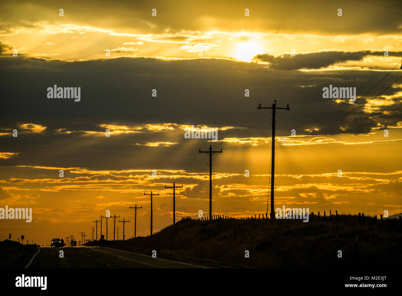 Road and utility poles at sunset Stock Photo - Alamy