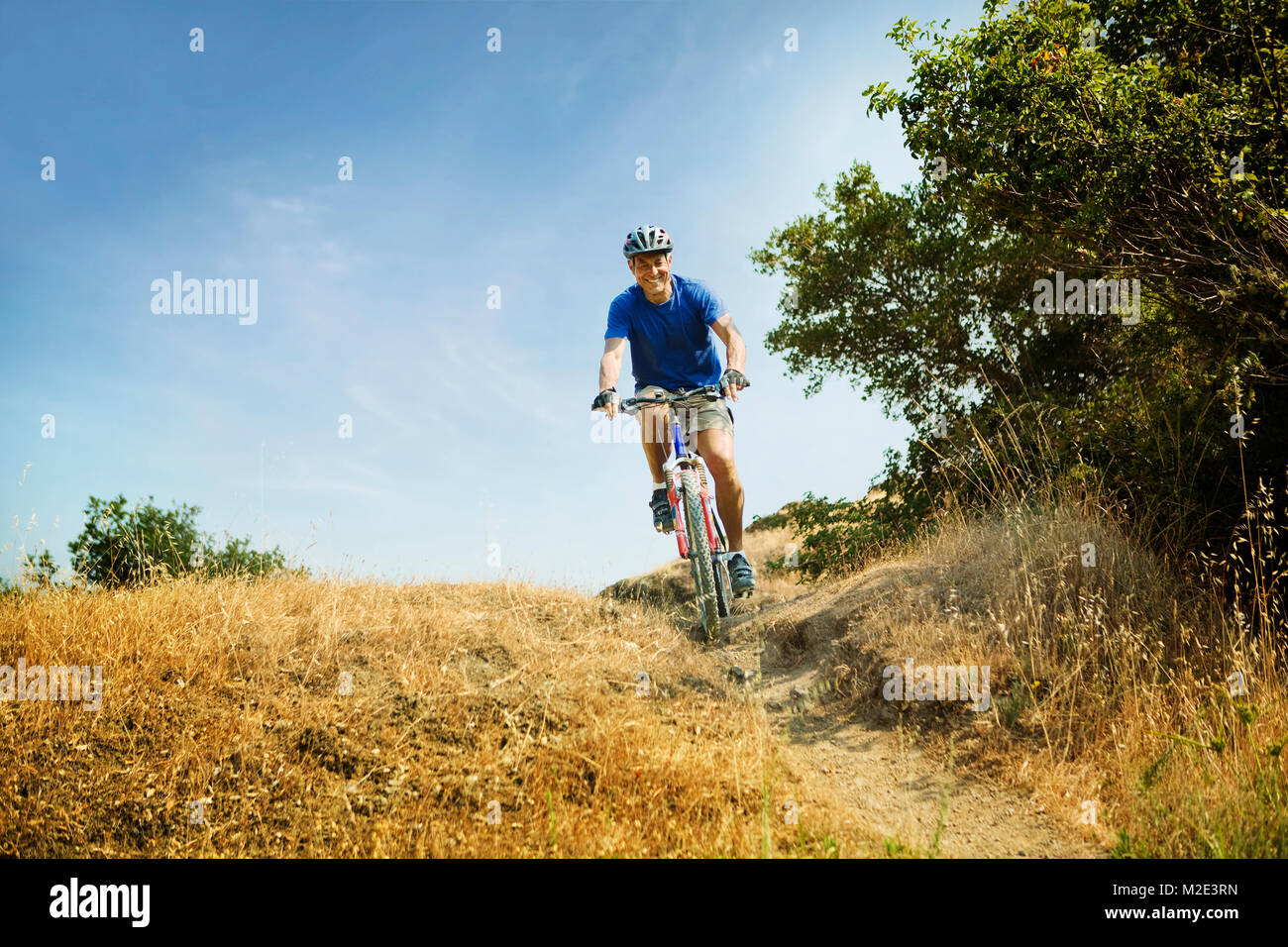 Person getting on bike and path hi-res stock photography and images - Alamy