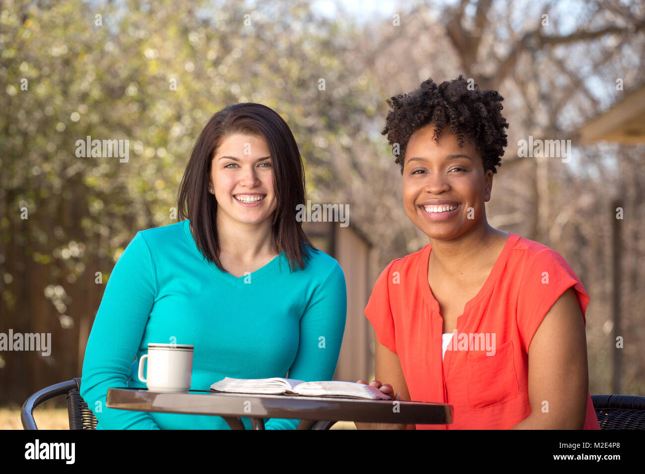 Two women reading bible together hi-res stock photography and images ...