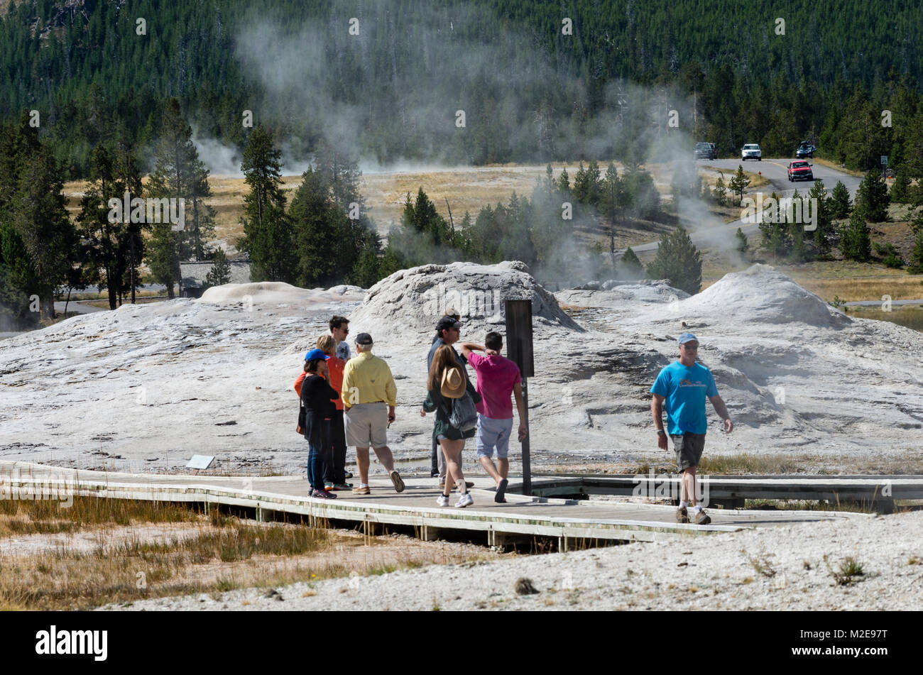 Visitors following the boardwalk in Upper Geyser Basin near the Lion ...