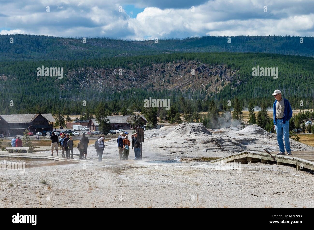 Visitors following the boardwalk in Upper Geyser Basin near the Lion ...