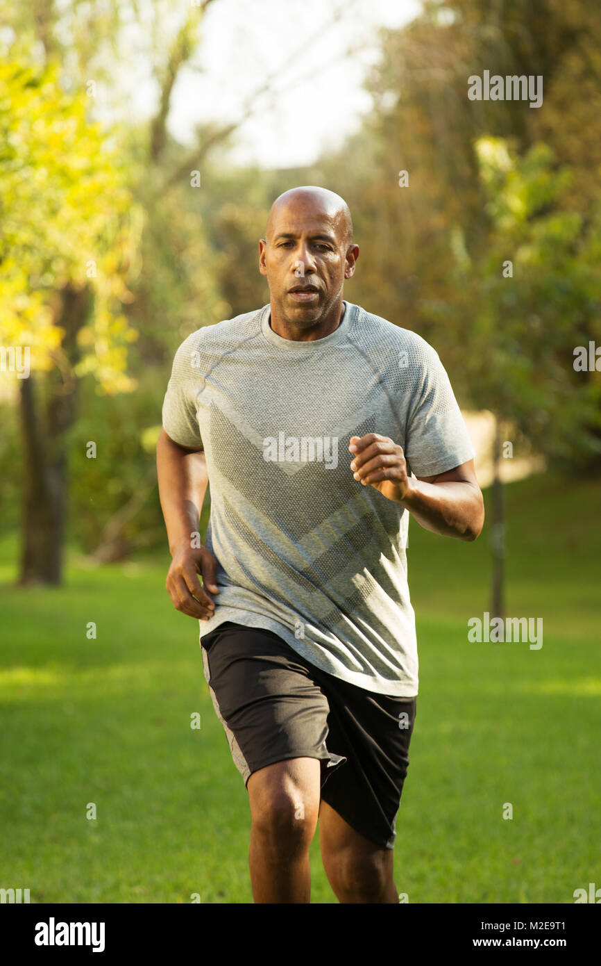 Fit African American man running Stock Photo - Alamy