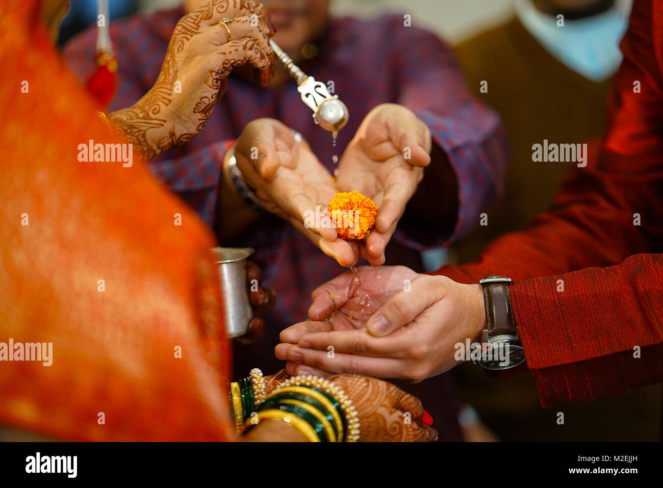 Traditional ritual in Hindu marriage where the water is made to flow ...