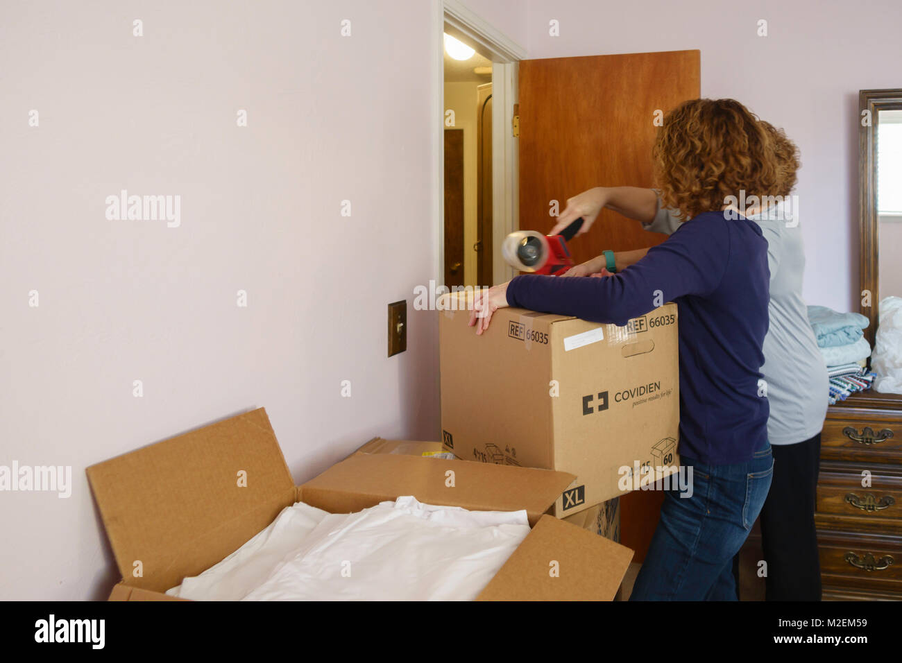 Adults helping each other out moving hi-res stock photography and ...