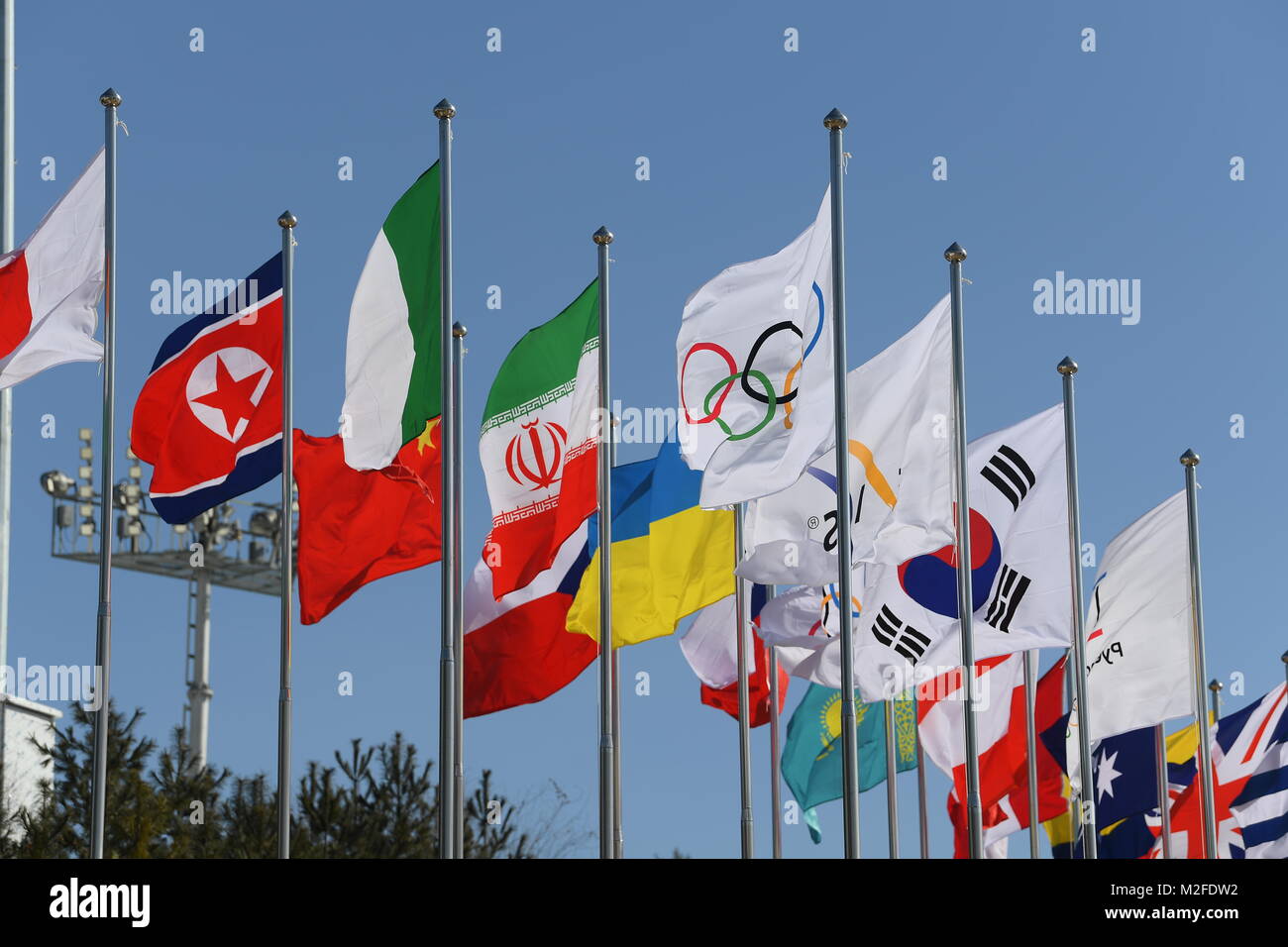 Pyeongchang, South Korea. 07th Feb, 2018. The Olympic flag (C), the ...
