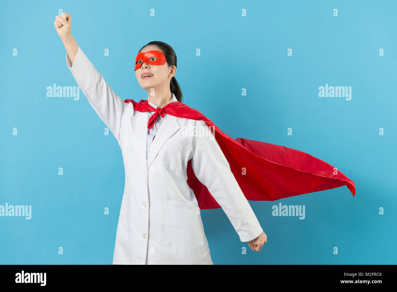 cheerful pretty female clinic doctor with superhero clothing and making ...