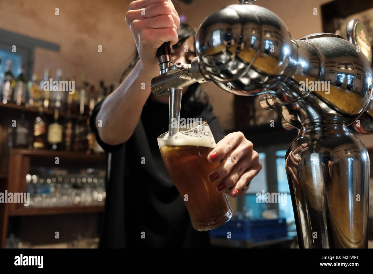 A bartender pouring beer in a bar in Tel Aviv Israel Stock Photo - Alamy
