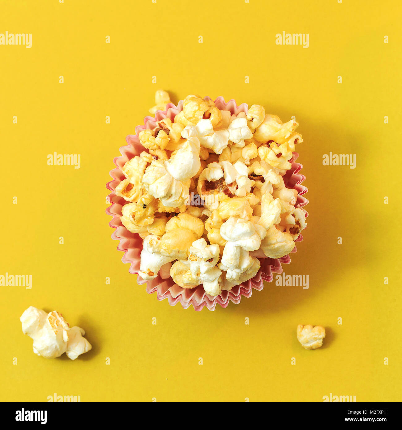 Popcorn on a yellow background. Square Stock Photo - Alamy